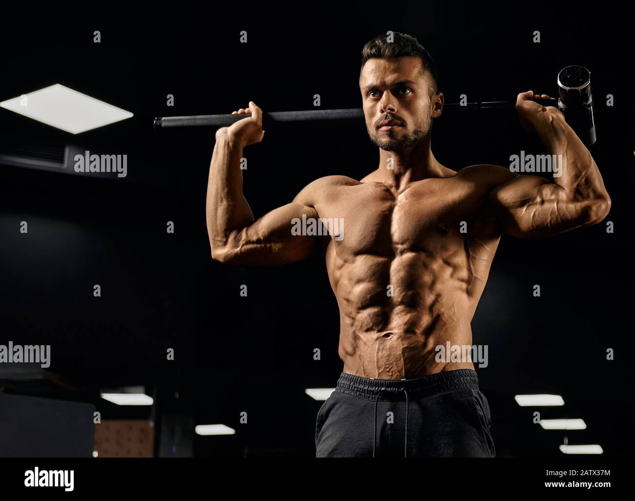 Close up of strong muscular handsome man holding big sledgehammer ...
