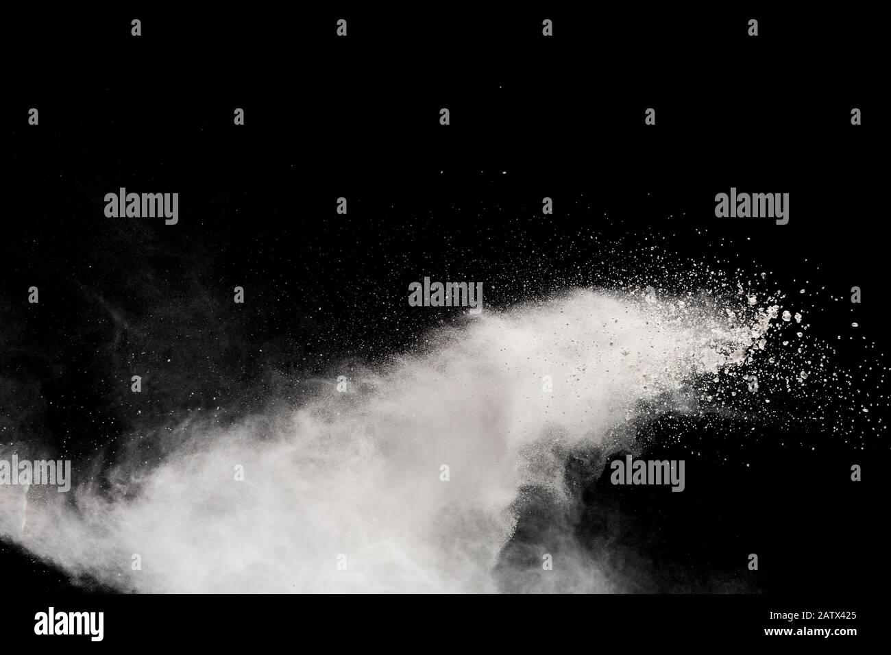 White powder explosion isolated on black background.White dust ...