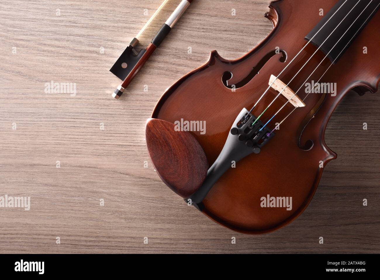 Violin body and bow on wood table. Top view. Horizontal composition ...