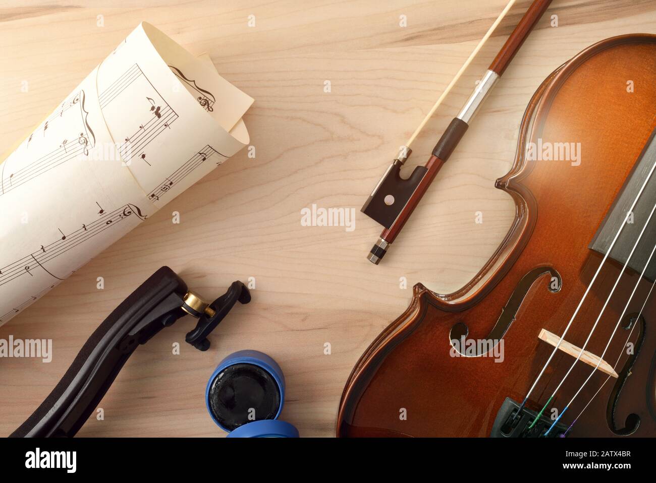 Violin and equipment on wooden table. Top view. Horizontal composition ...