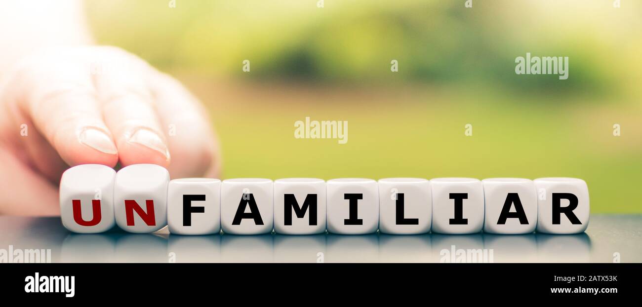 Hand turns dice and changes the word "unfamiliar" to "familiar Stock ...