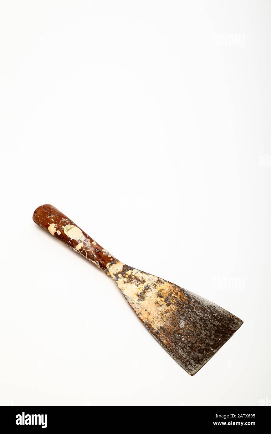 Old used decorators scraper isolated on a white background with space ...