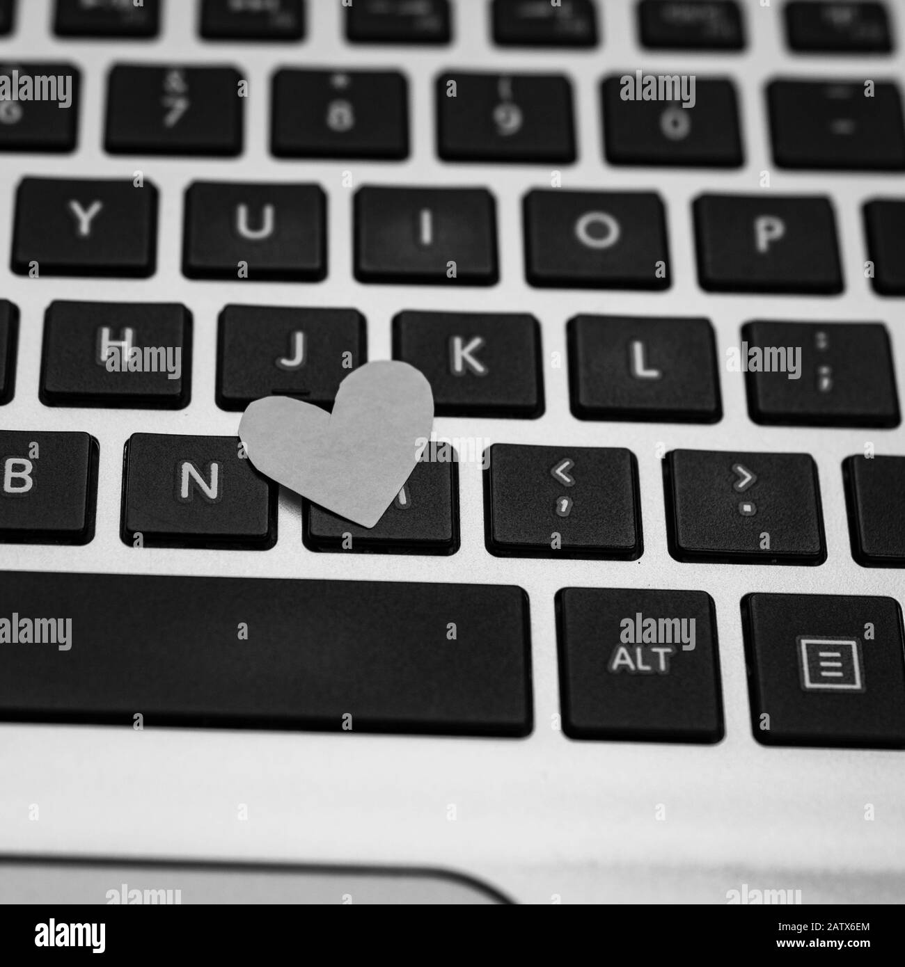 Heart shaped paper cut out on keyboard, love message and Valentine`s ...