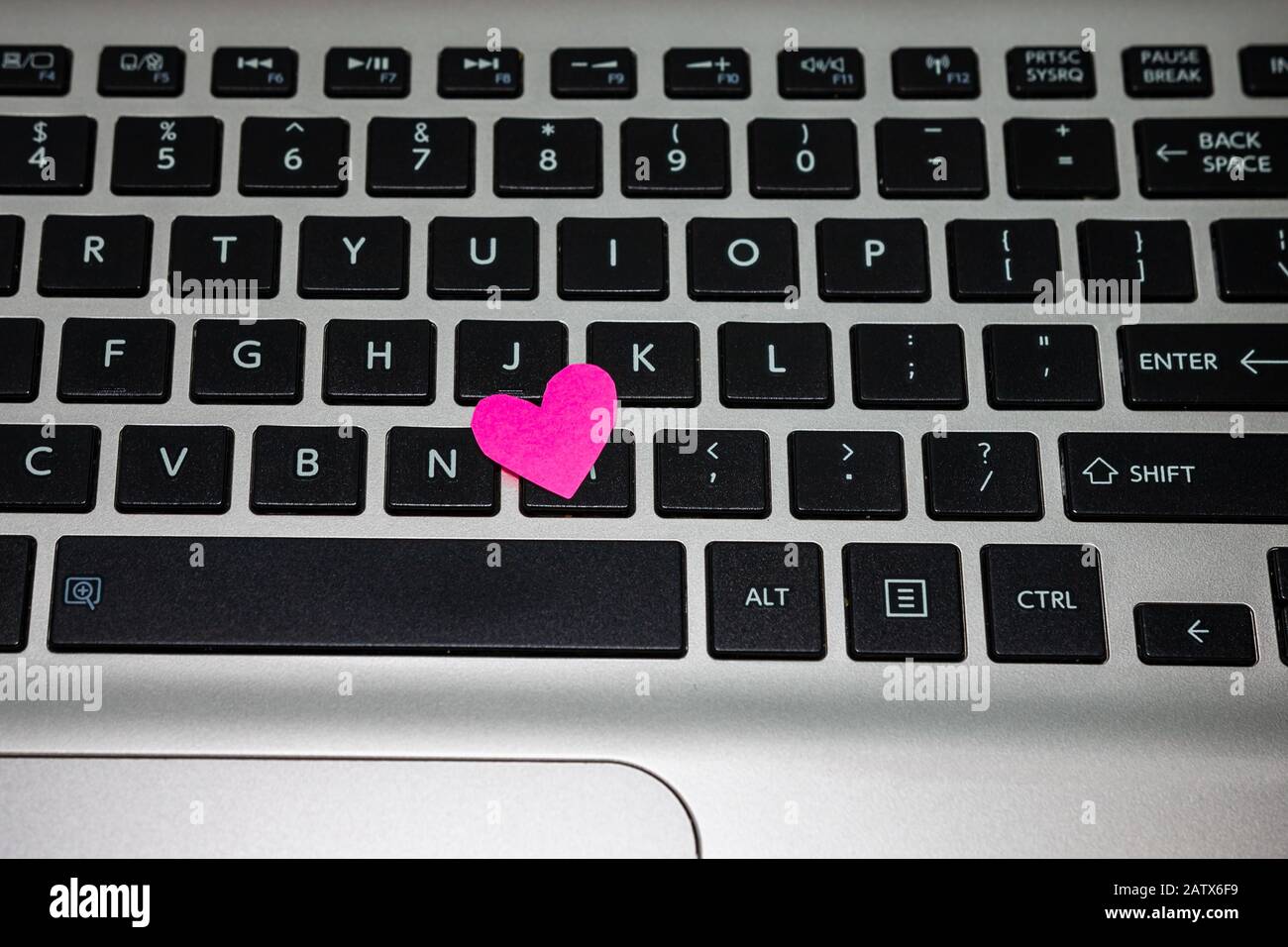 Heart shaped paper cut out on keyboard, love message and Valentine`s ...