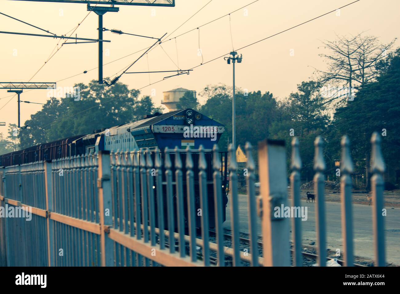 A goods train passing through railway station platform. Diesel ...
