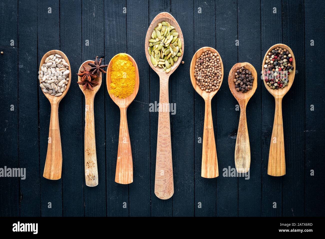 Various spices spoons on stone table. On a wooden board. Top view. Free ...