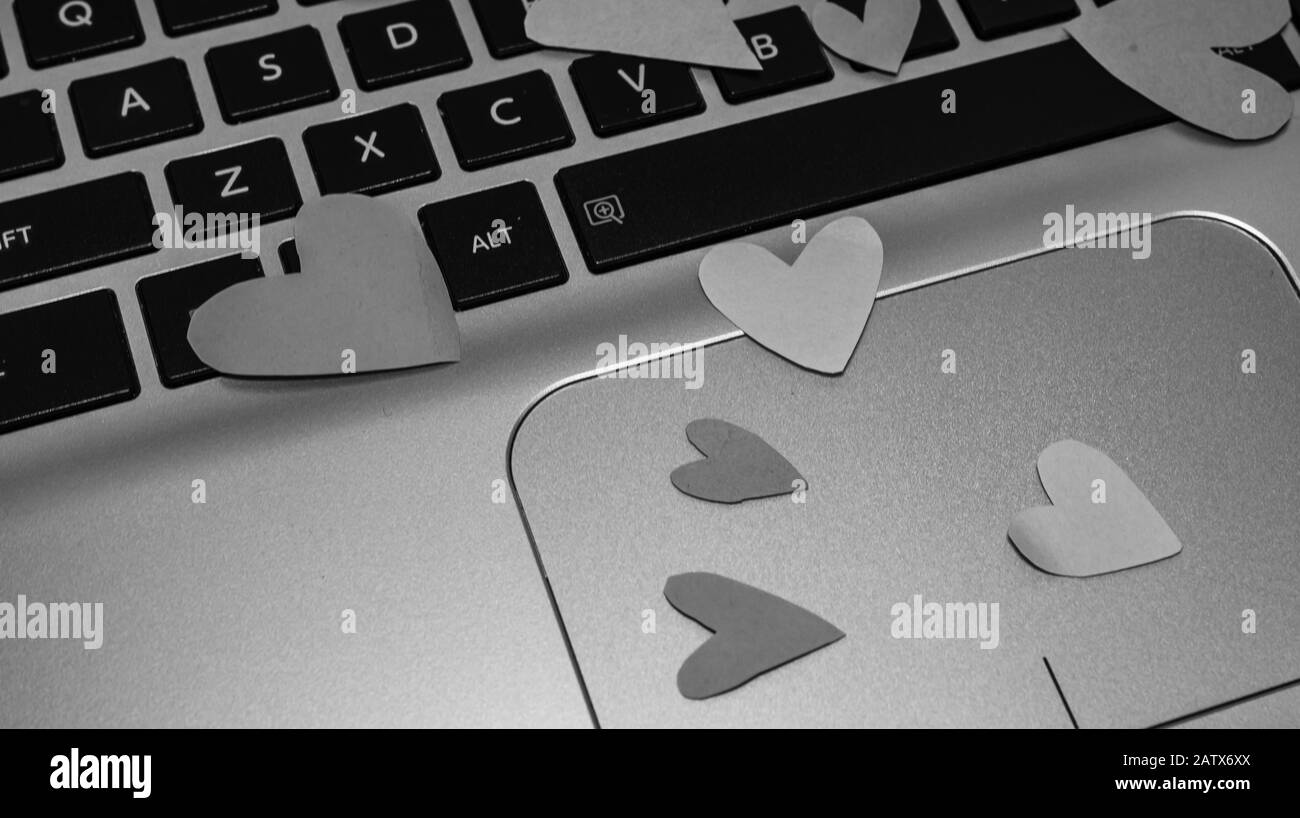 Heart shaped paper cut out on keyboard, love message and Valentine`s ...