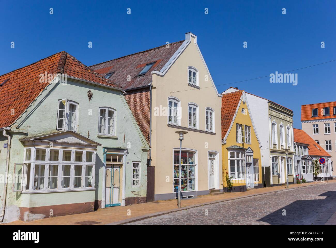 Colorful houses at a cobblestoned street in Tonder, Denmark Stock Photo ...