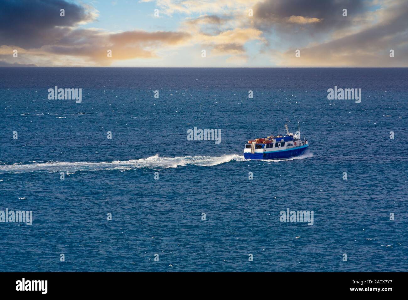 Blue Ferry Across Blue at Sunrise Stock Photo - Alamy