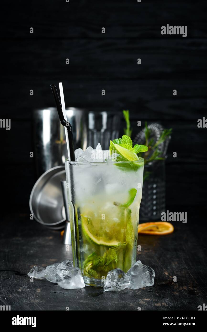 Alcohol Cocktail Mojito with menthol, lime and rum in a glass. On a ...