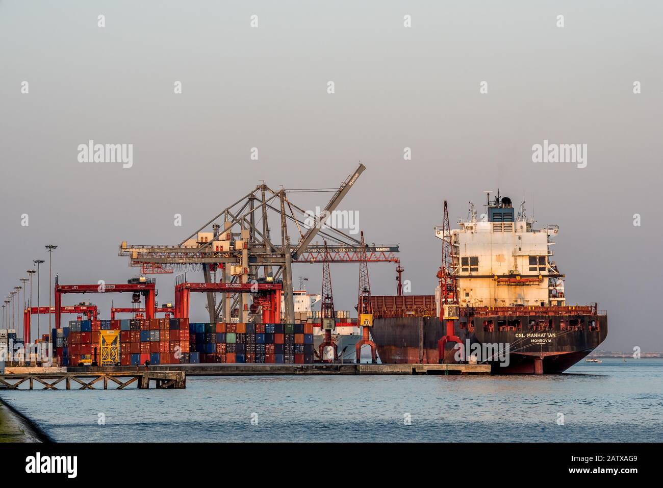 Container ship loading unloading at shipping terminal on river Tejo ...
