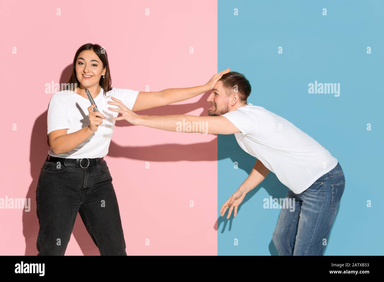 My choice. Fighting for TV channel remote. Young man and woman in ...