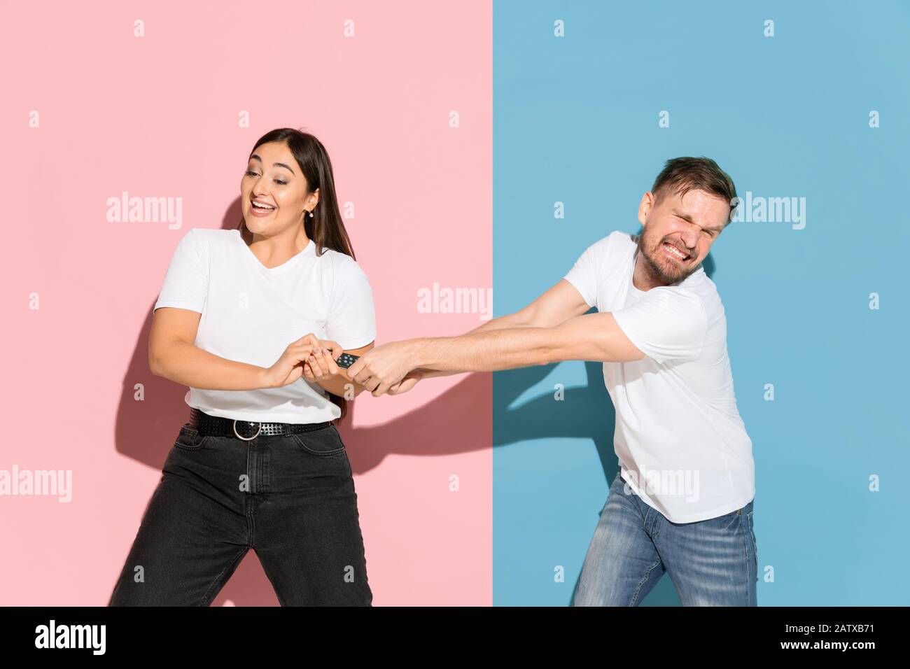 My choice. Fighting for TV channel remote. Young man and woman in ...