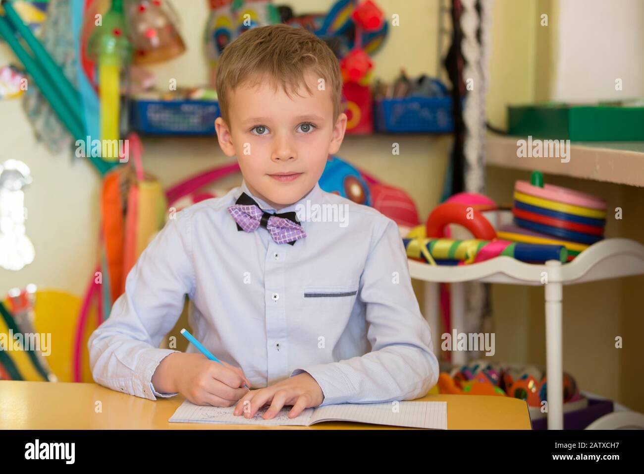Beautiful children at the table in kindergarten or elementary school ...