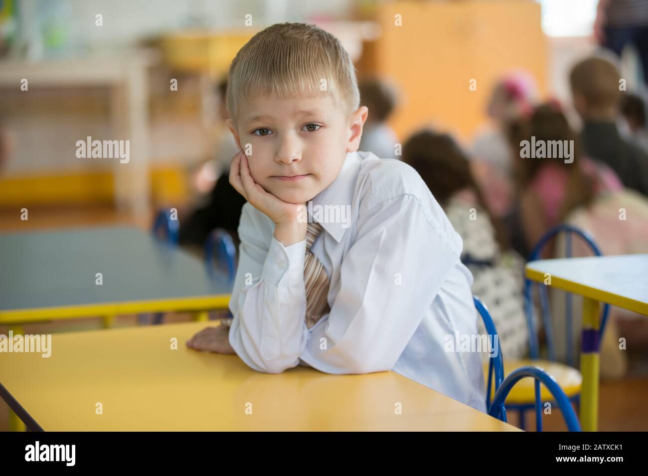 Beautiful children at the table in kindergarten or elementary school ...