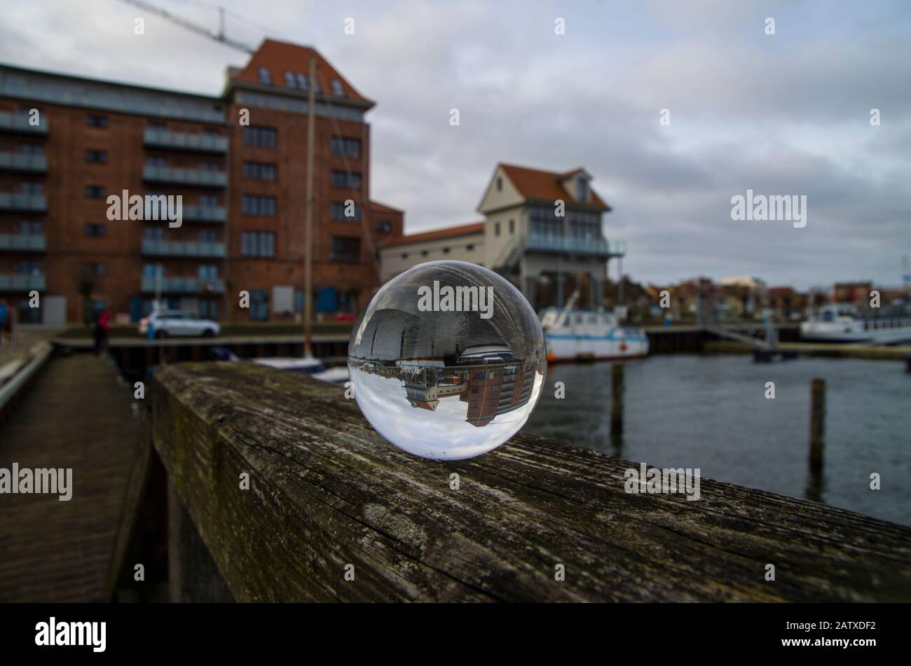 Lensball, view into crystal ball on harbor. Fisheye effect with ...