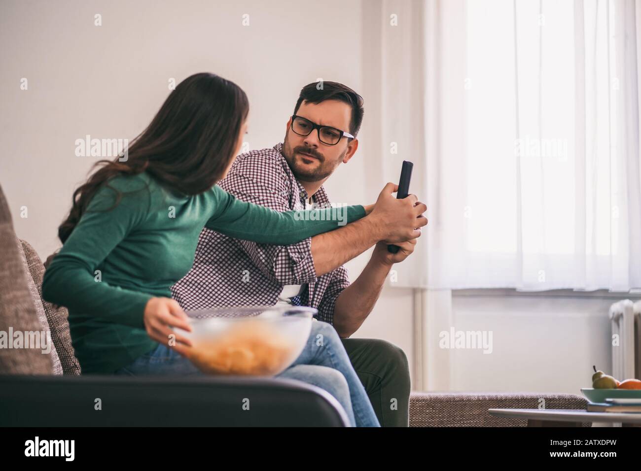 Angry couple watching tv hi-res stock photography and images - Alamy