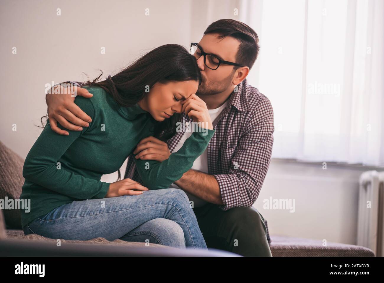 Woman is sad and depressed, her man is consoling her Stock Photo - Alamy