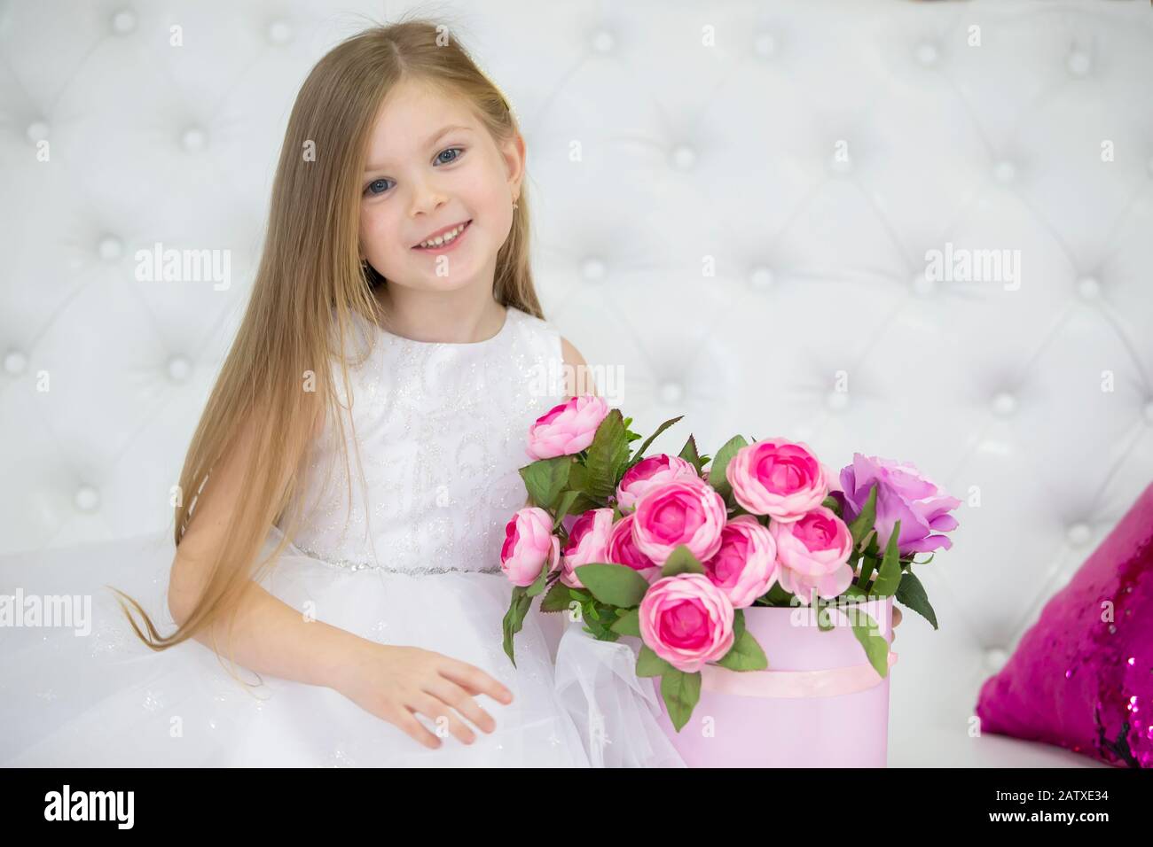 Beautiful child girl with flowers Stock Photo - Alamy