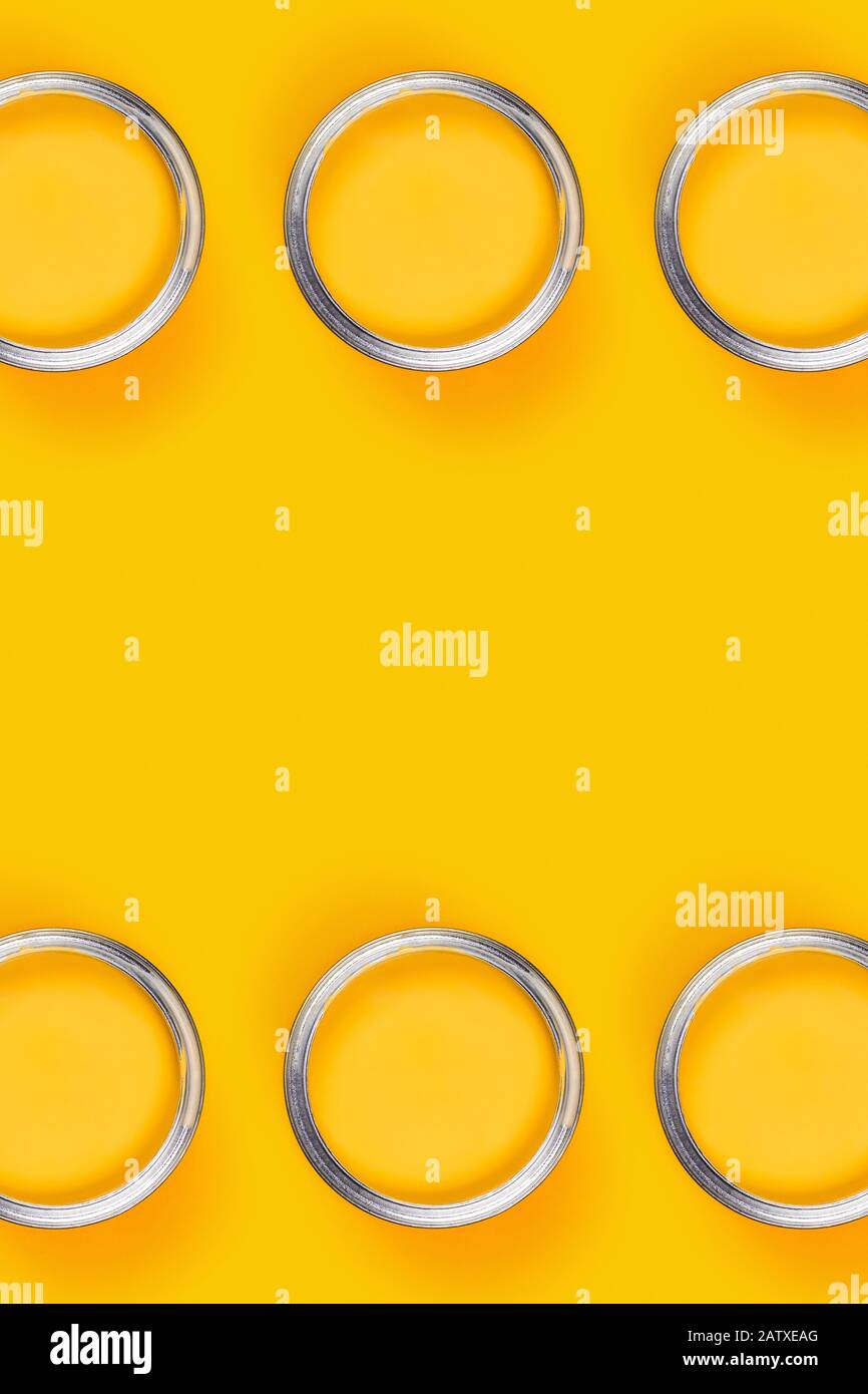 Repair concept. Yellow background with six paint cans. Vertical picture ...