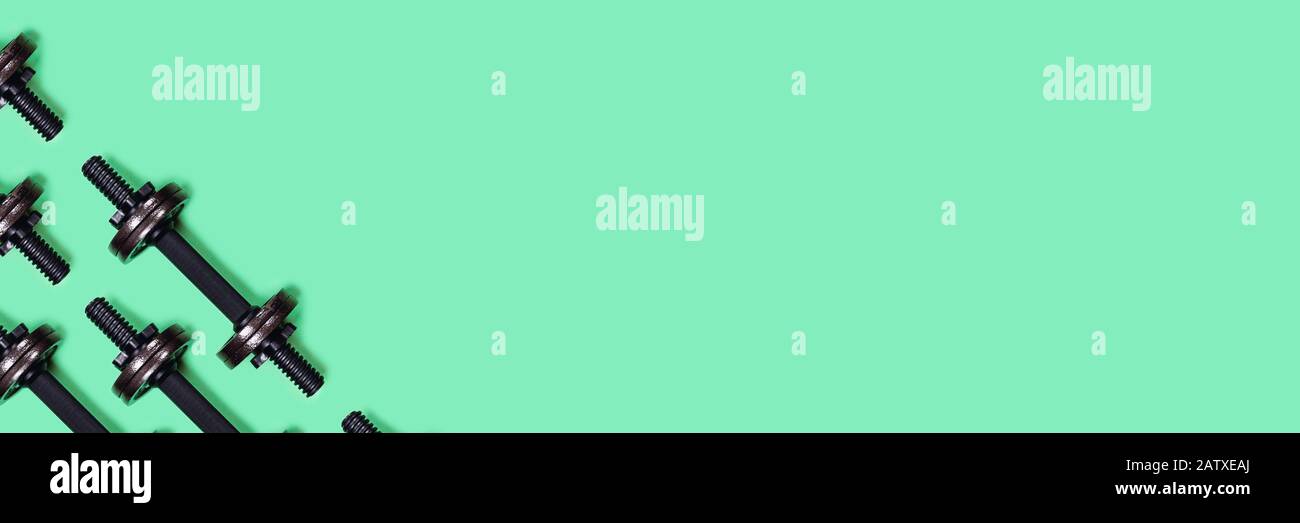 Sports web-banner. Dumbbell on mint green background. Flat lay, top ...