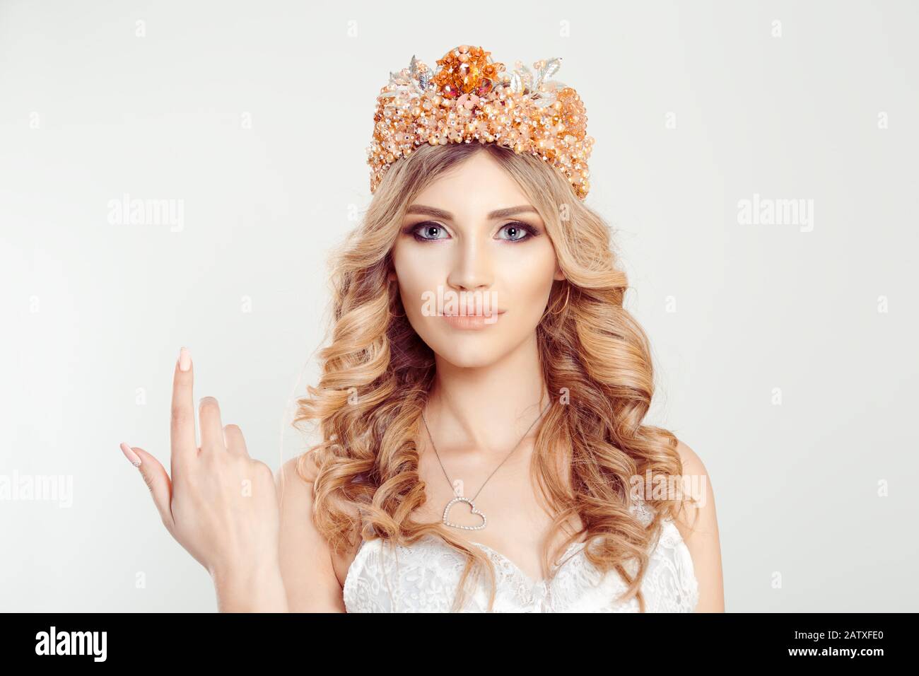 Woman with the crown shows come here gestures with her index finger ...