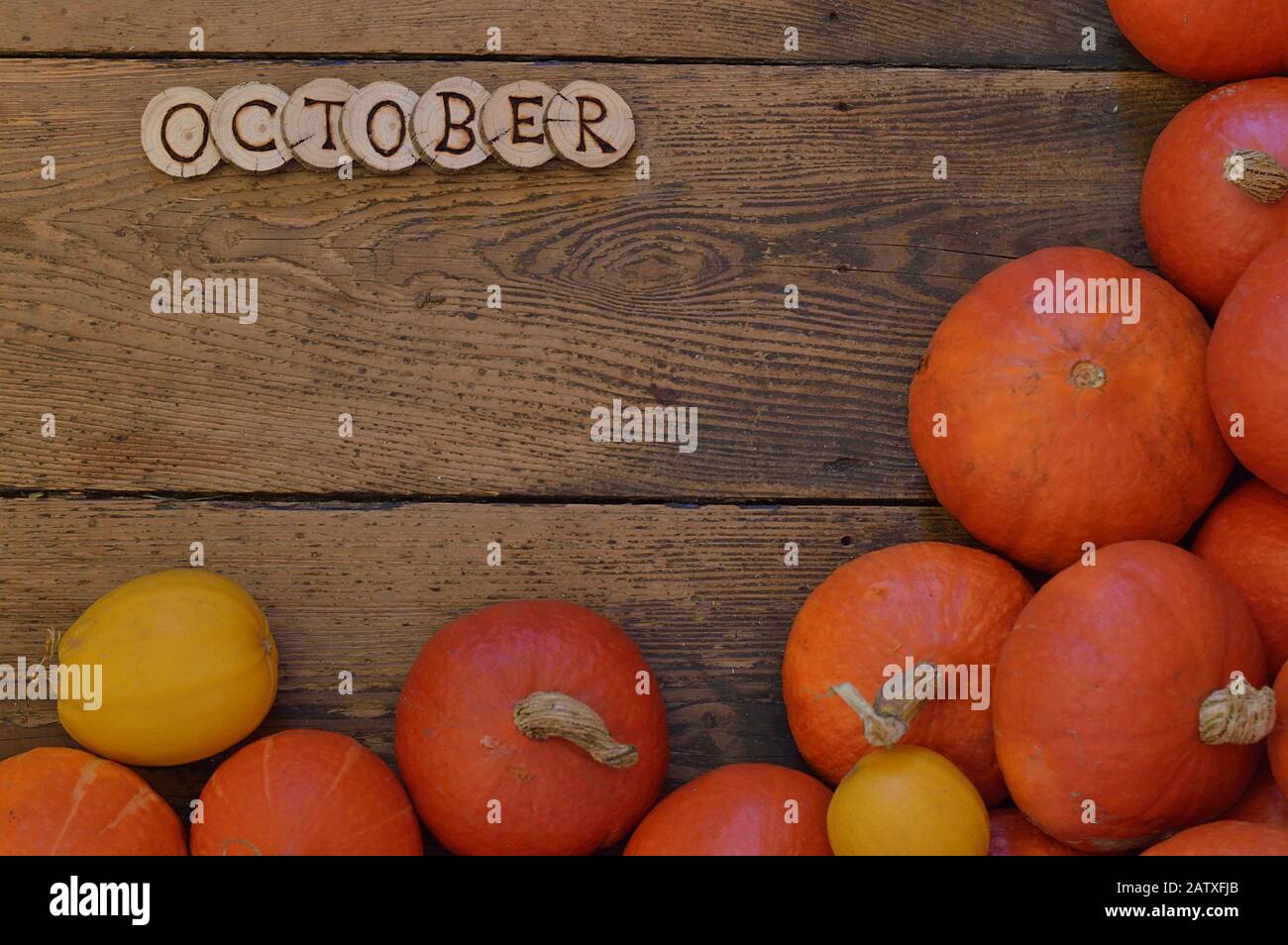 Pumpkins on wooden planks with pieces of wood lettering the word of the ...