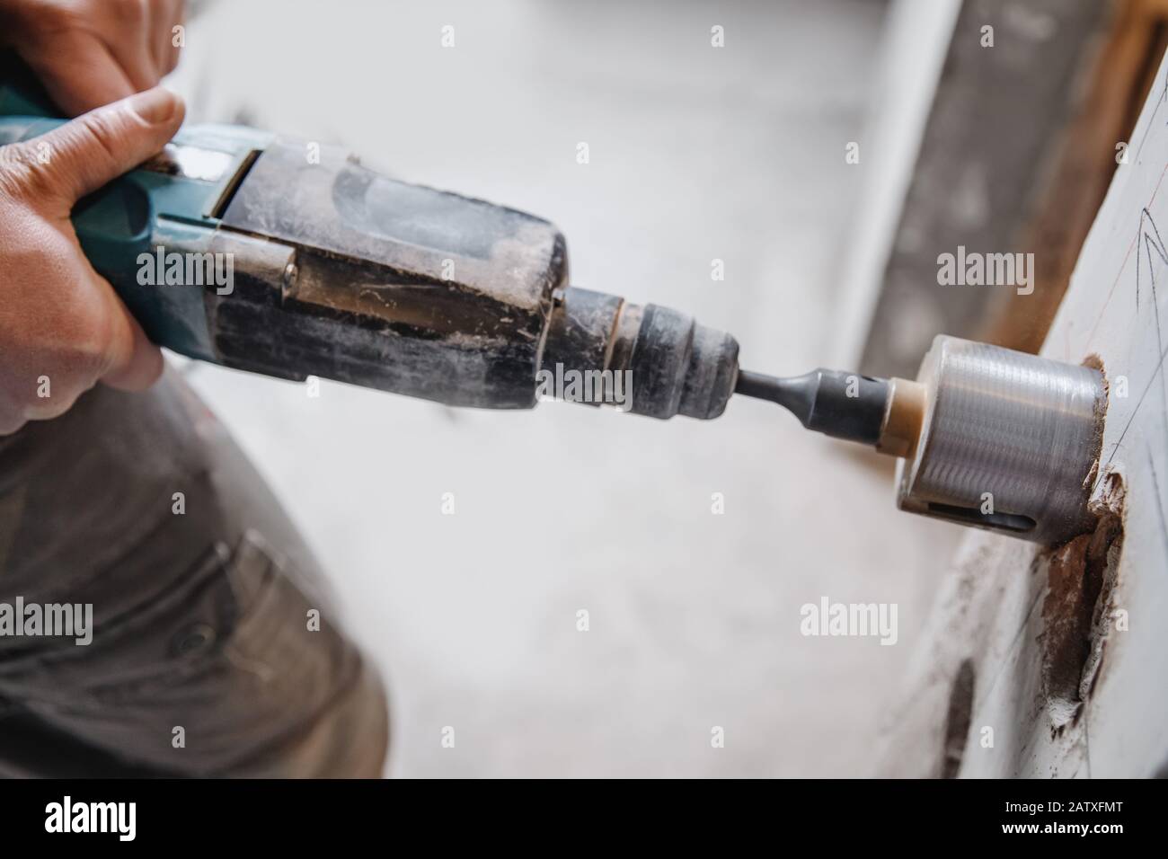 Boring hole in wall for electric outlet by power hammer drills tool ...