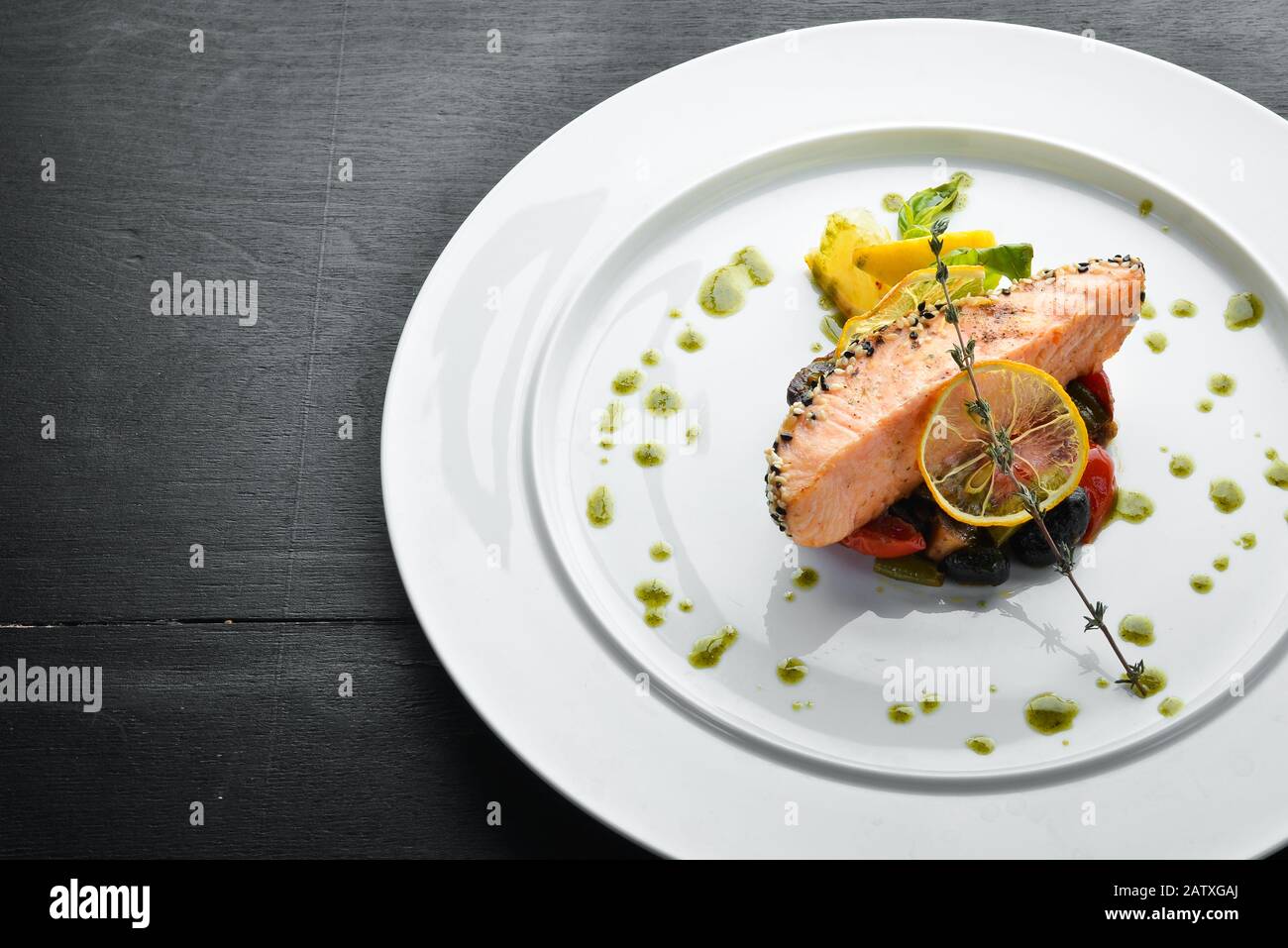 Baked salmon fillet with sesame and vegetables. Dishes, food. Top view ...