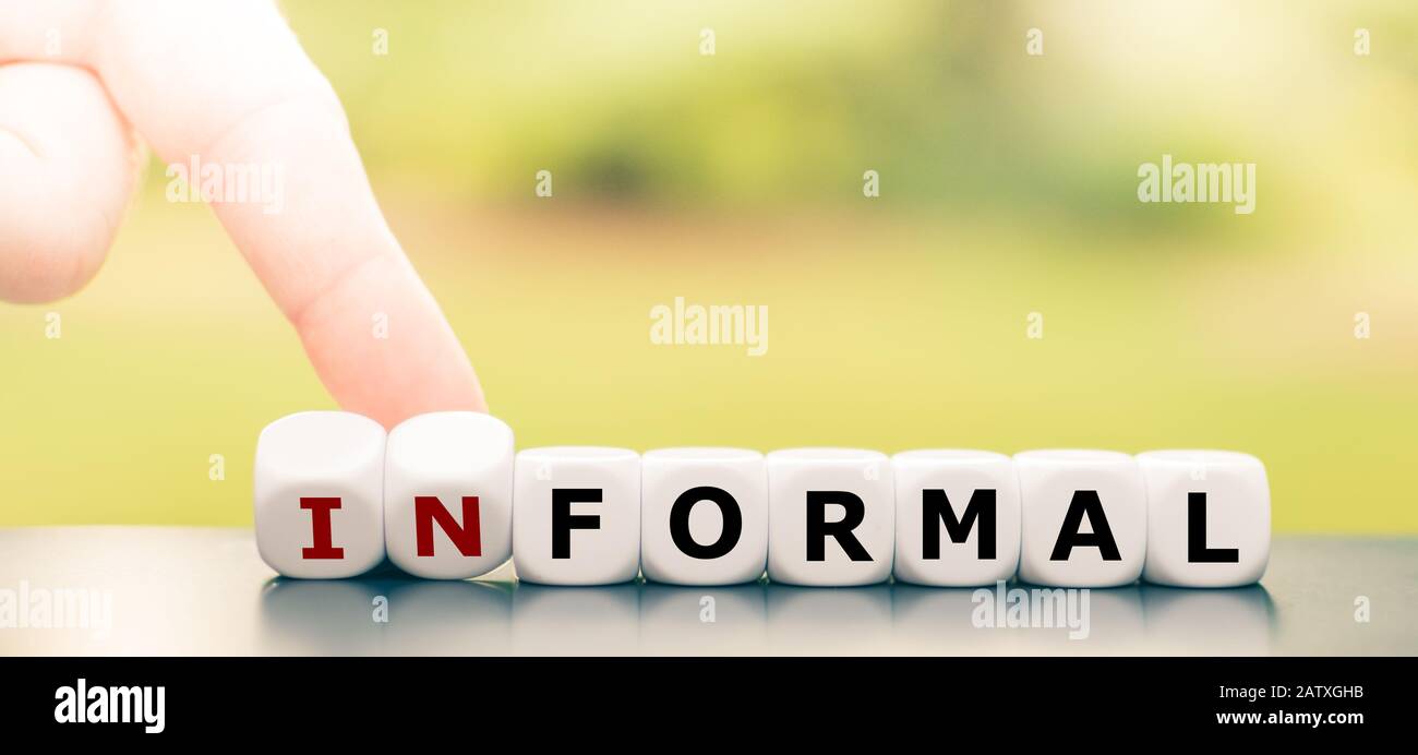 Hand turns dice and changes the word "informal" to "formal Stock Photo ...