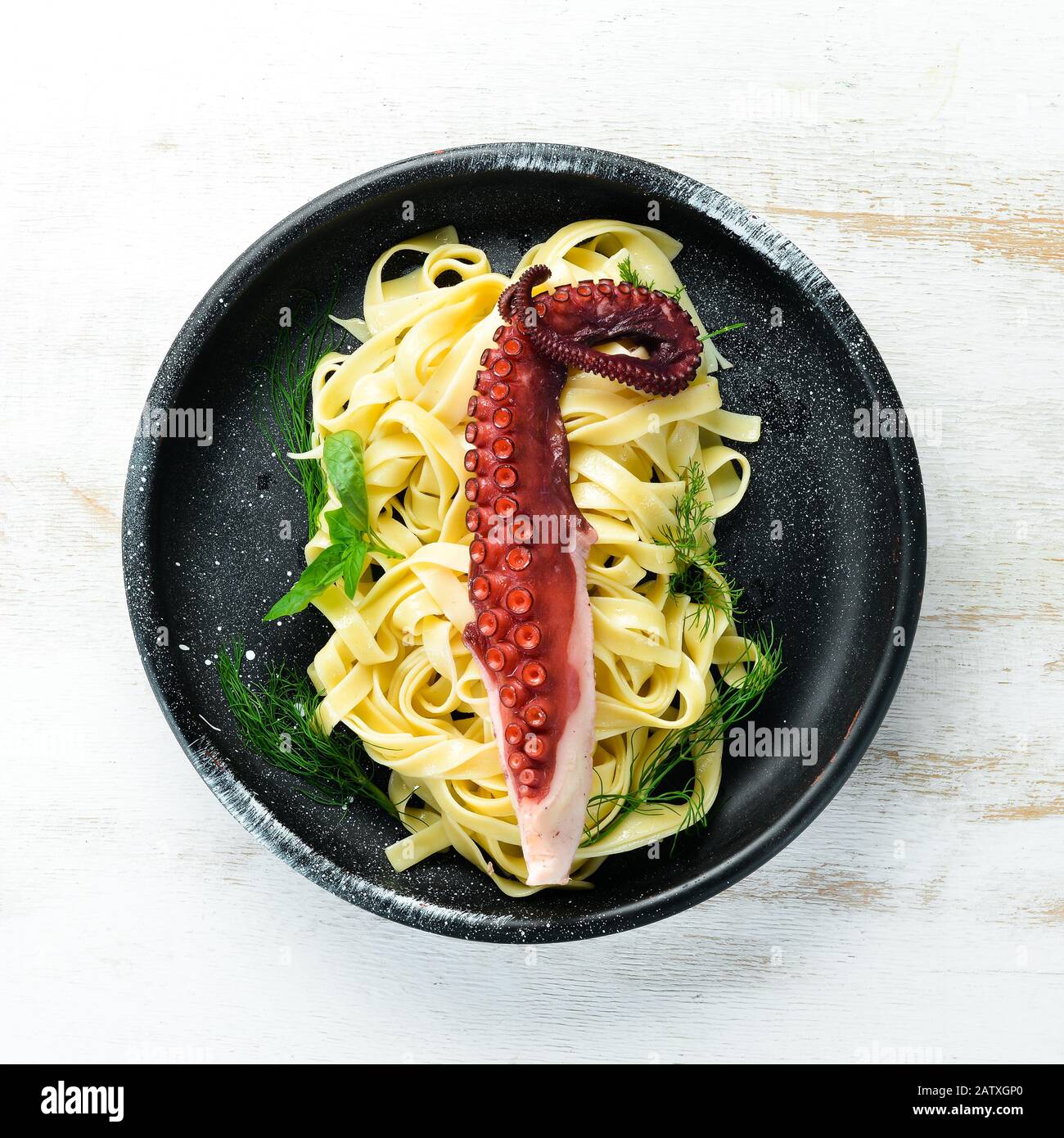 Pasta with octopus on a stone plate. Top view. Free copy space Stock ...