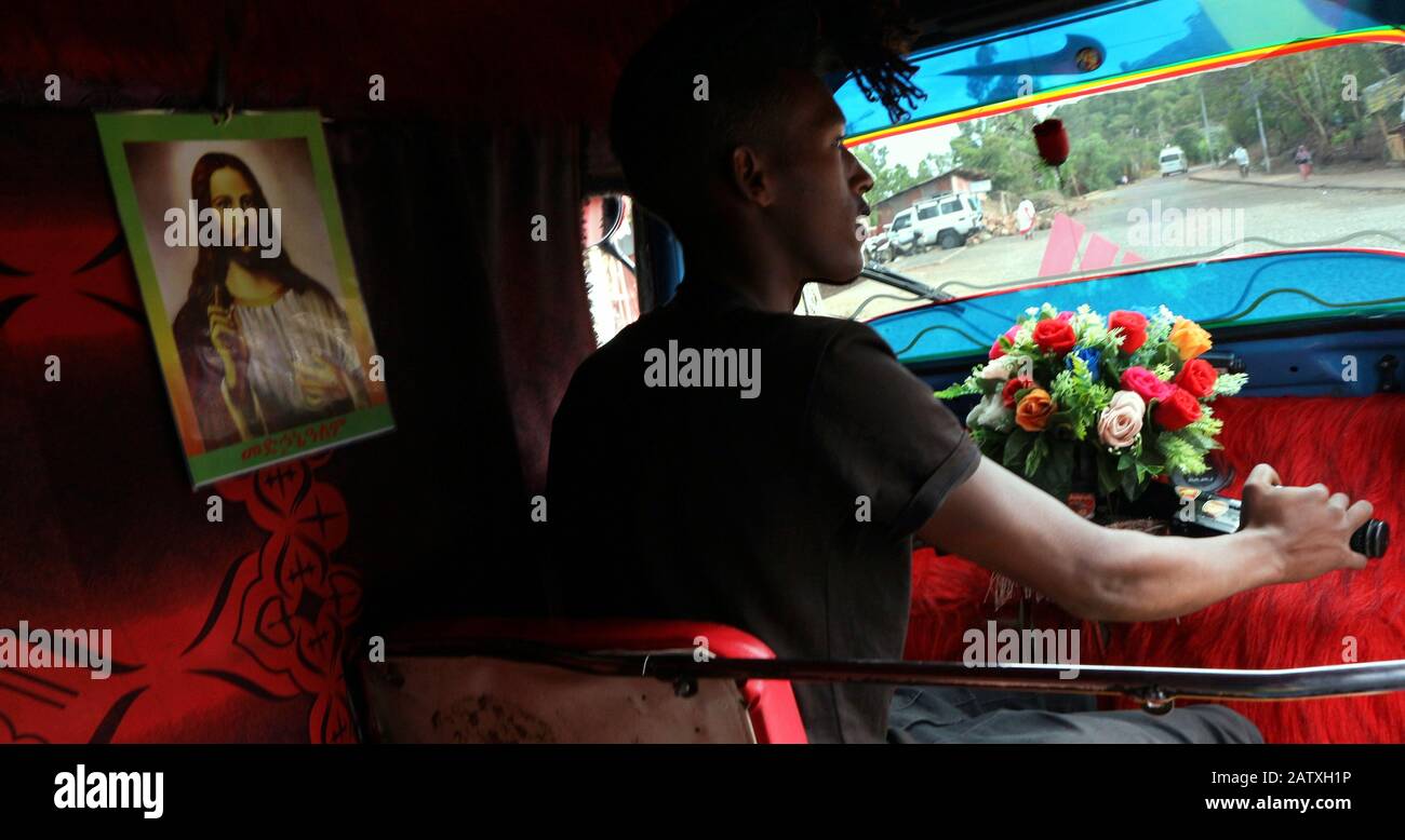 Rickshaw driver with picture of Jesus Christ Stock Photo - Alamy