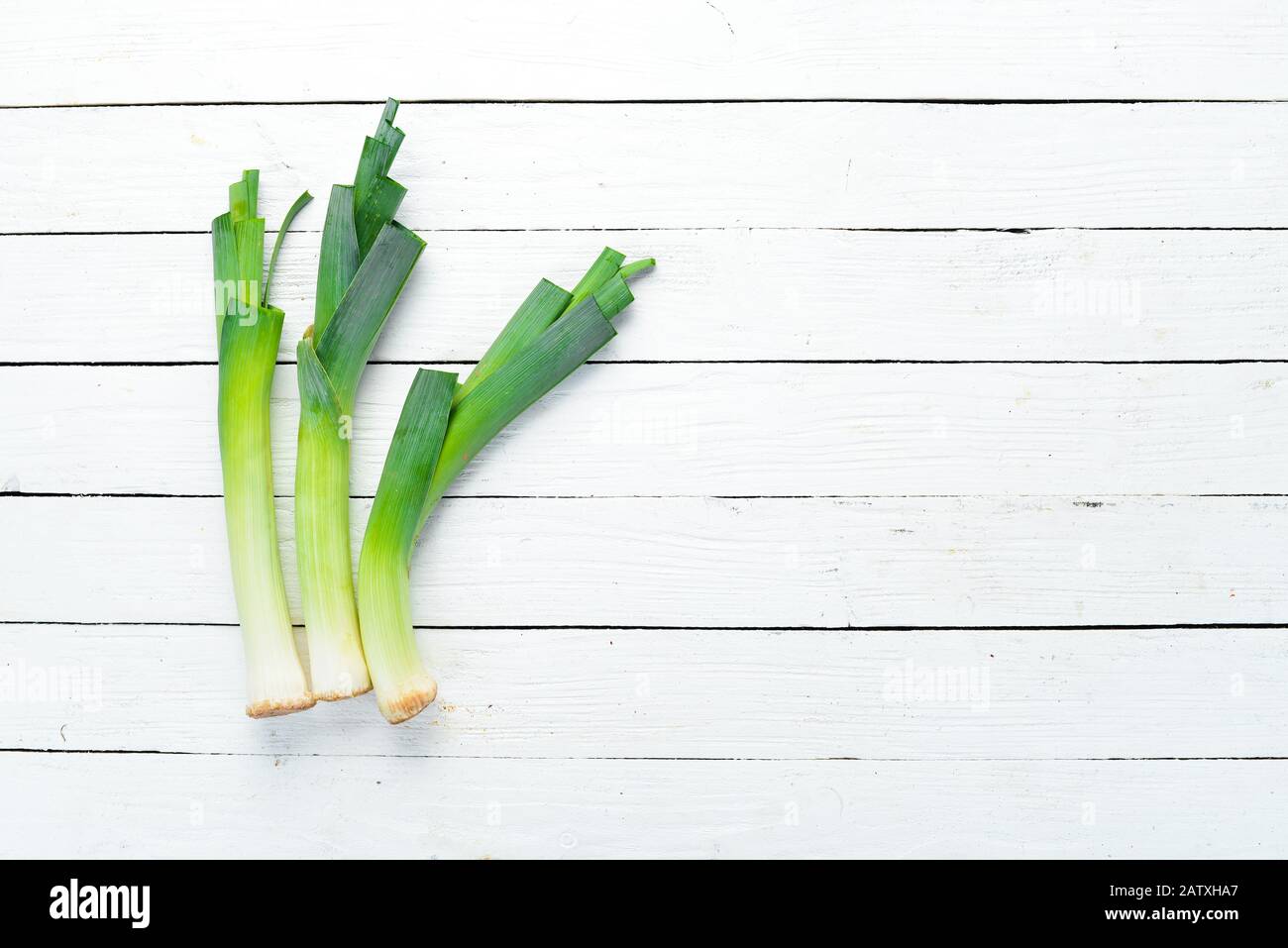 Leek on a white wooden background. Vegetables for healthy eating. Top ...