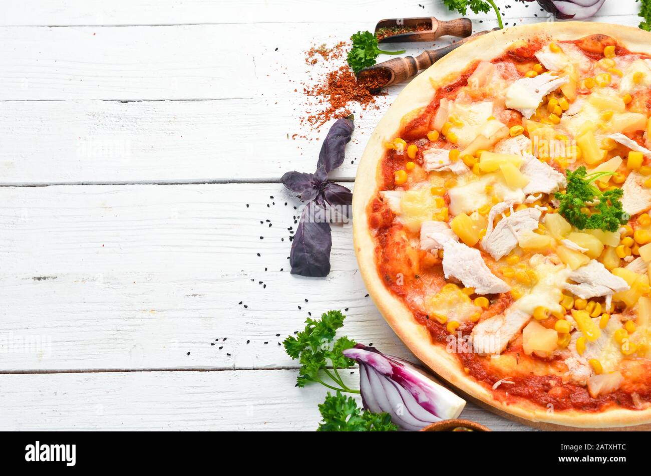 Traditional pizza with chicken, pineapple and corn. Top view. free ...