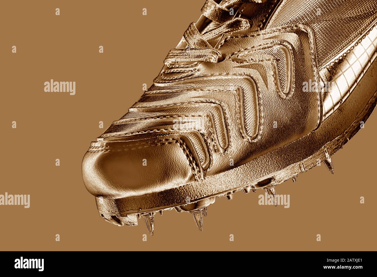 Fragment of a gold sneaker with spikes on a gold background Stock Photo ...