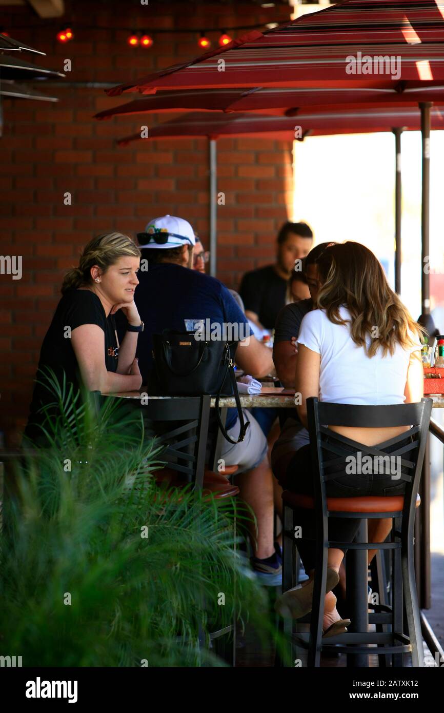 Men and women enjoying a meal at an outdoor cafe hi-res stock ...