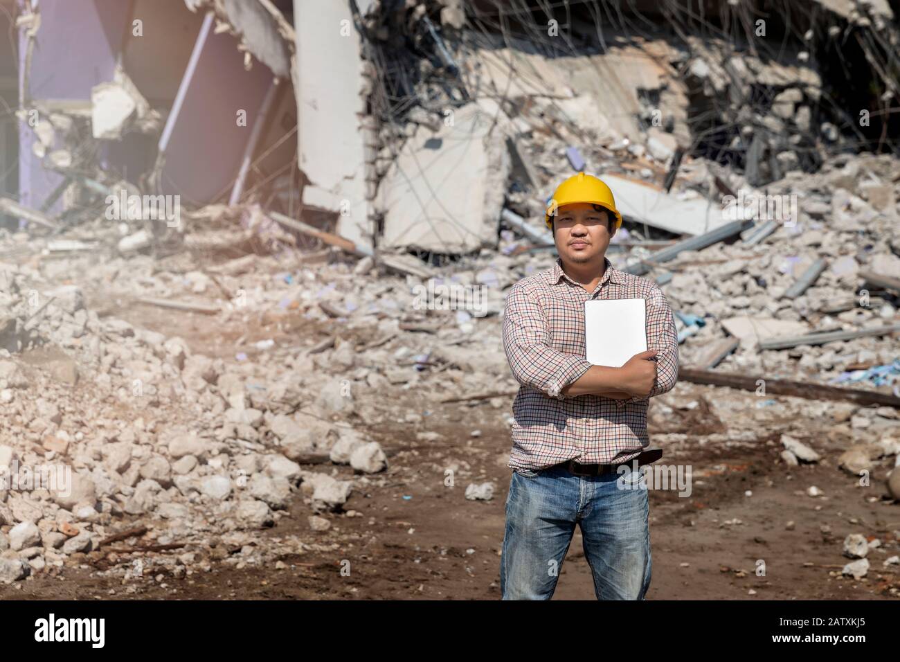 Engineer holding tablet is checking for destruction, demolishing ...