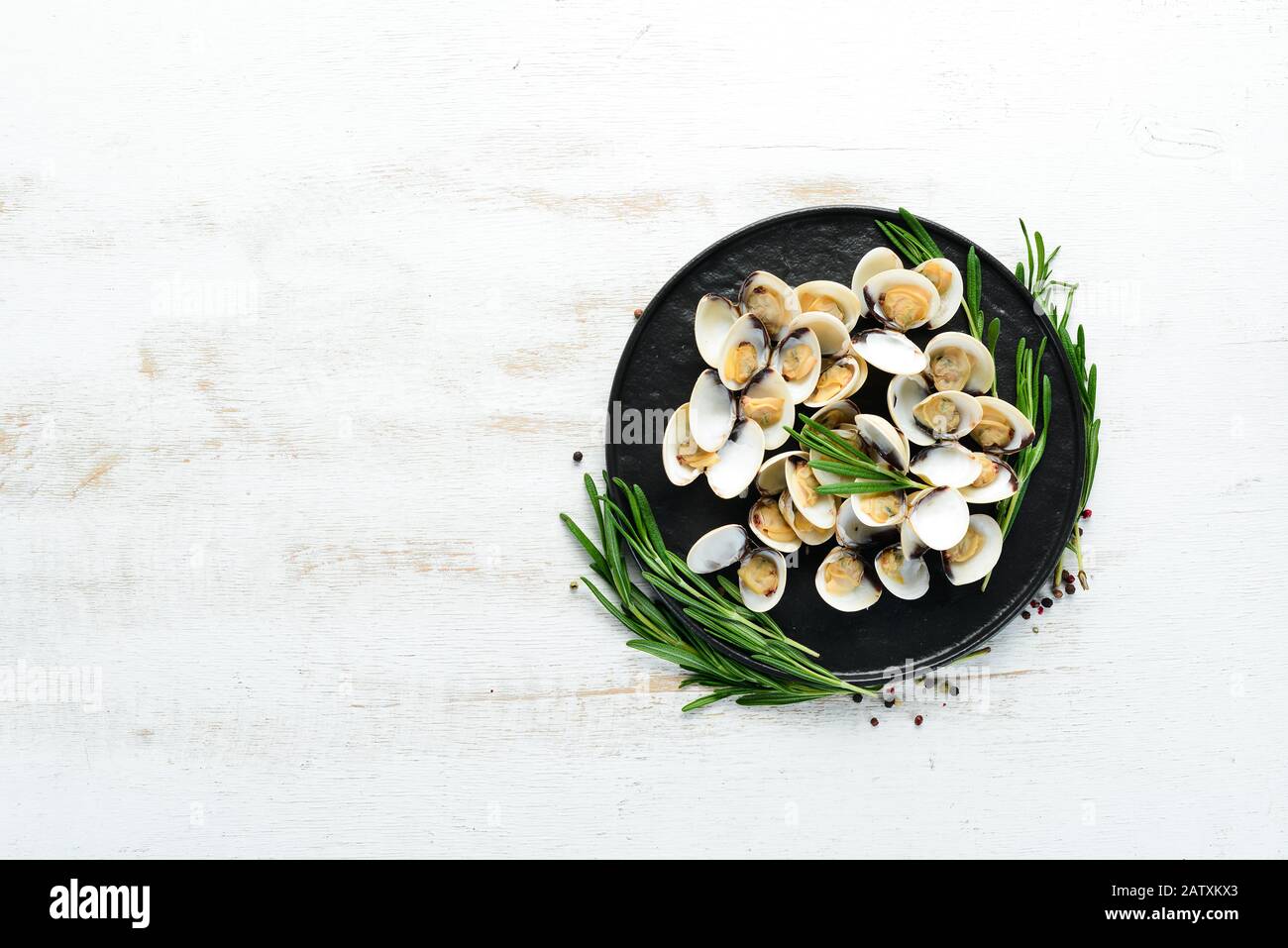 Boiled clams in a plate. Seafood on a white background Stock Photo - Alamy