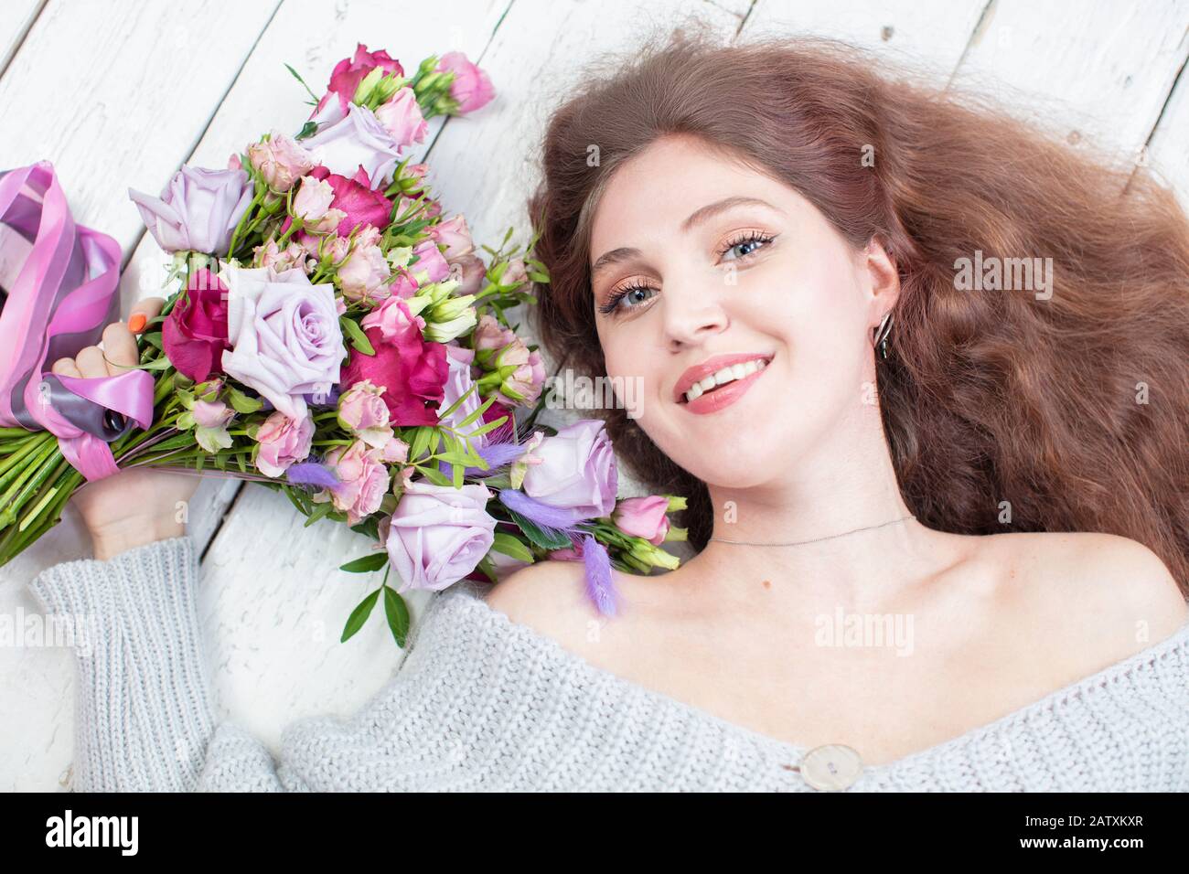 Portrait of a woman with flowers from above. girl with long hair with a ...