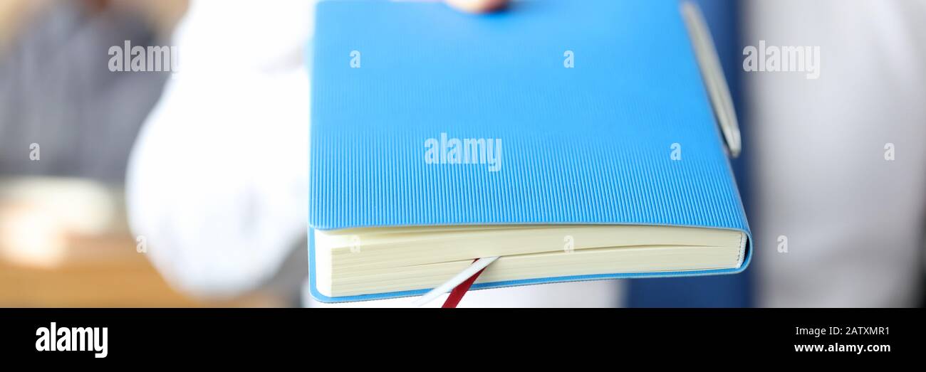 Male businessman hand hold blue diary Stock Photo - Alamy