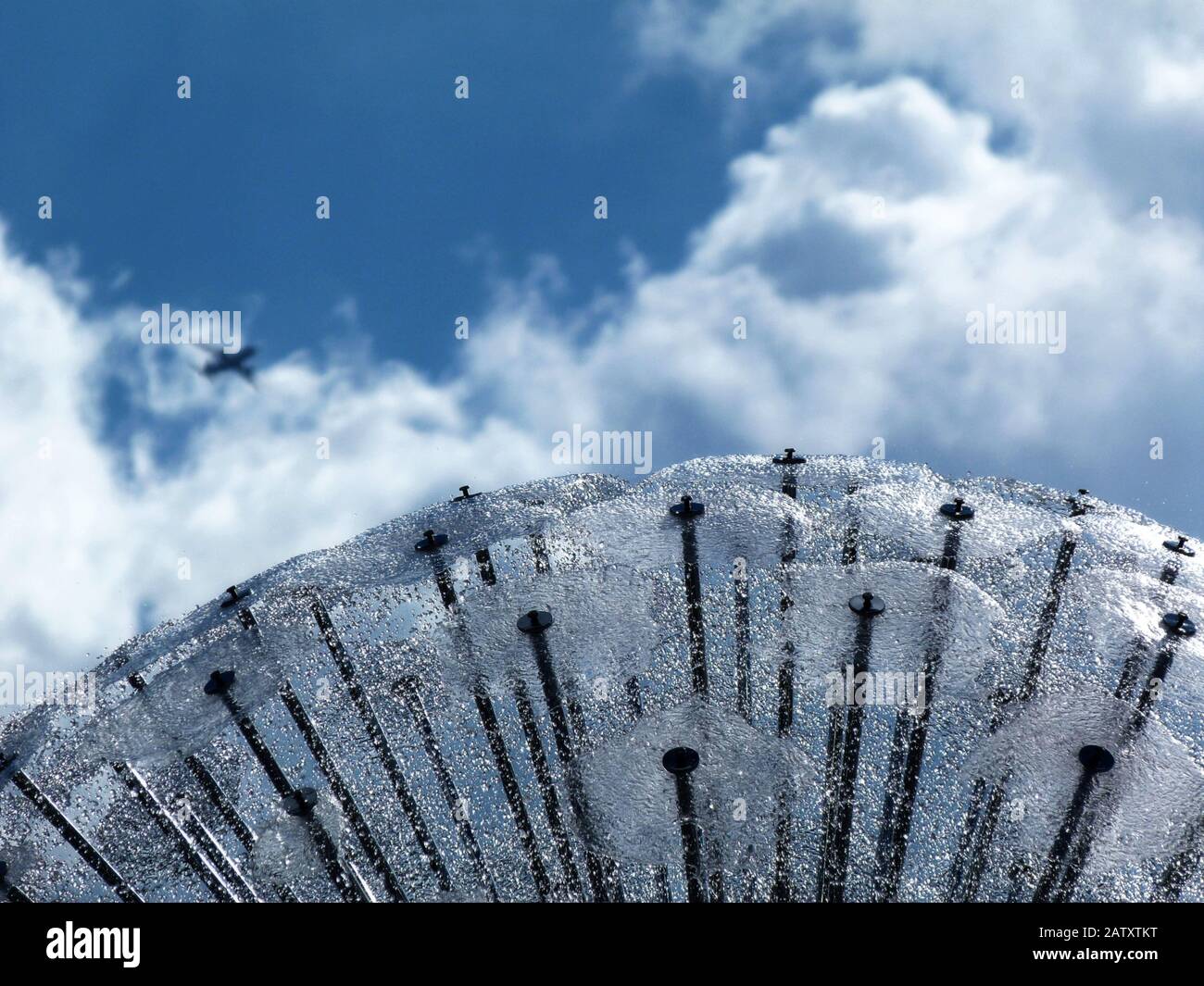 sphere shaped water fountain sprinkler with dynamic white clouds on ...