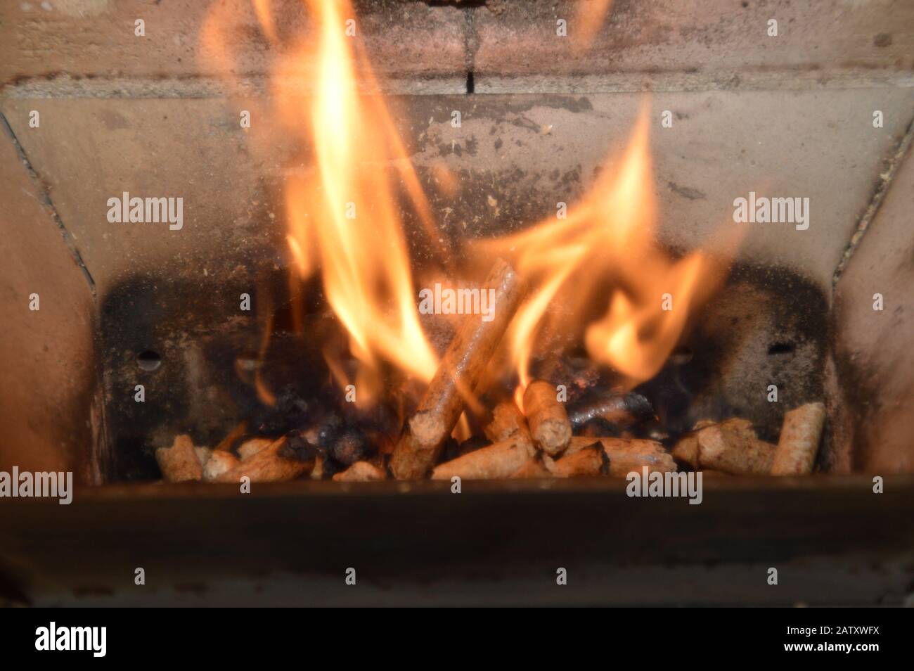 Wood pellets in the fire Stock Photo - Alamy