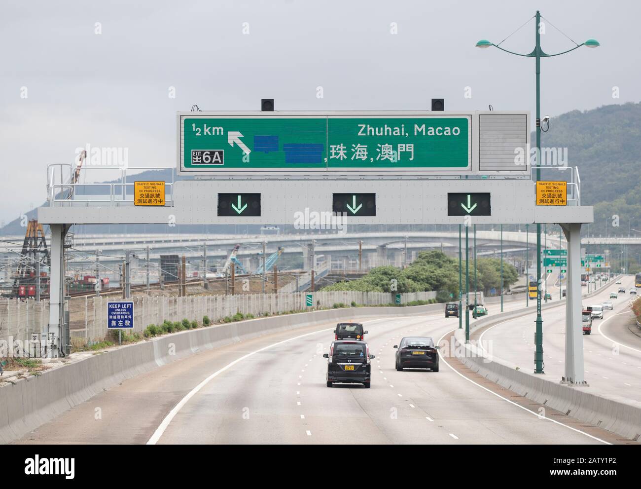 A road sign of Zhuhai, Macao direction seen on North Lantau Highway ...