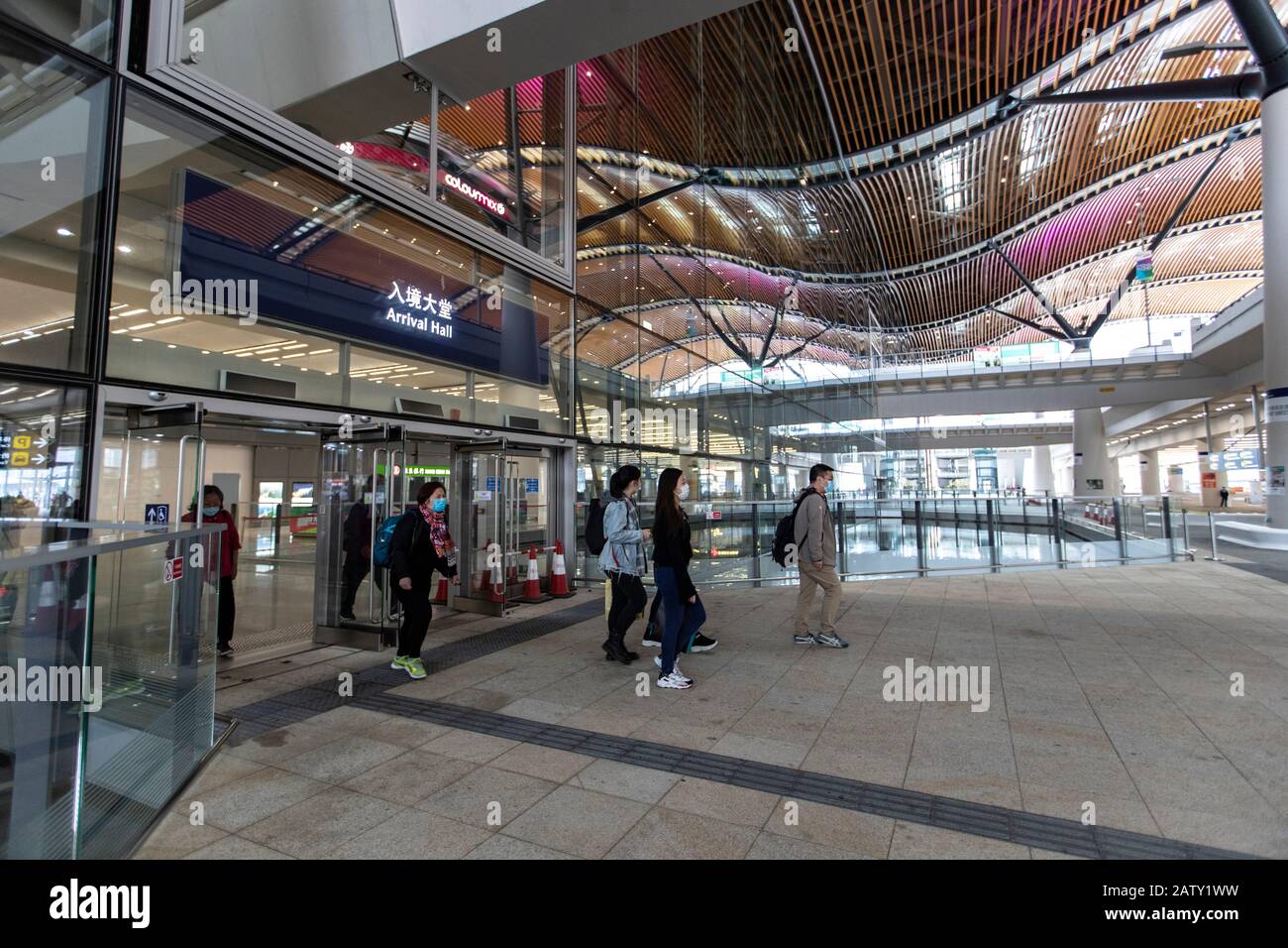 People wearing protective masks arrive in Hong Kong through Hong Kong ...