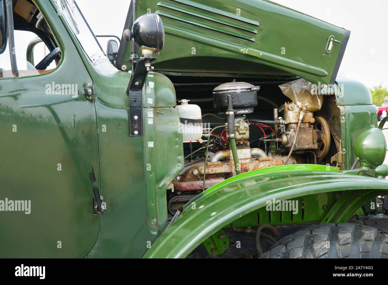 View of the Engine of an old restored truck through the open bonnet ...