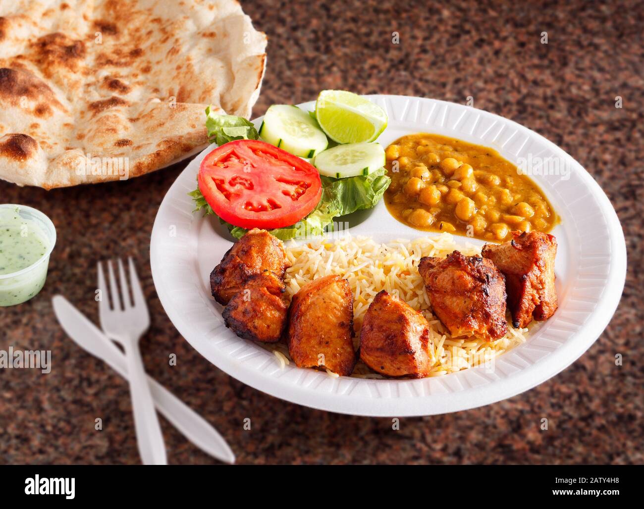 Grilled chicken kabob entree with rice, chickpeas, salad and naan bread ...
