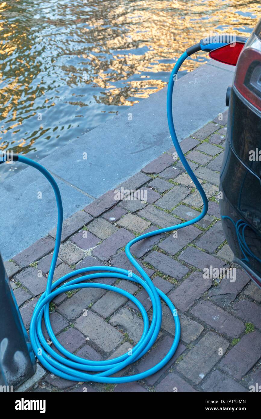 Charging Plug in Electric Vehicle Near Canal Water Stock Photo - Alamy