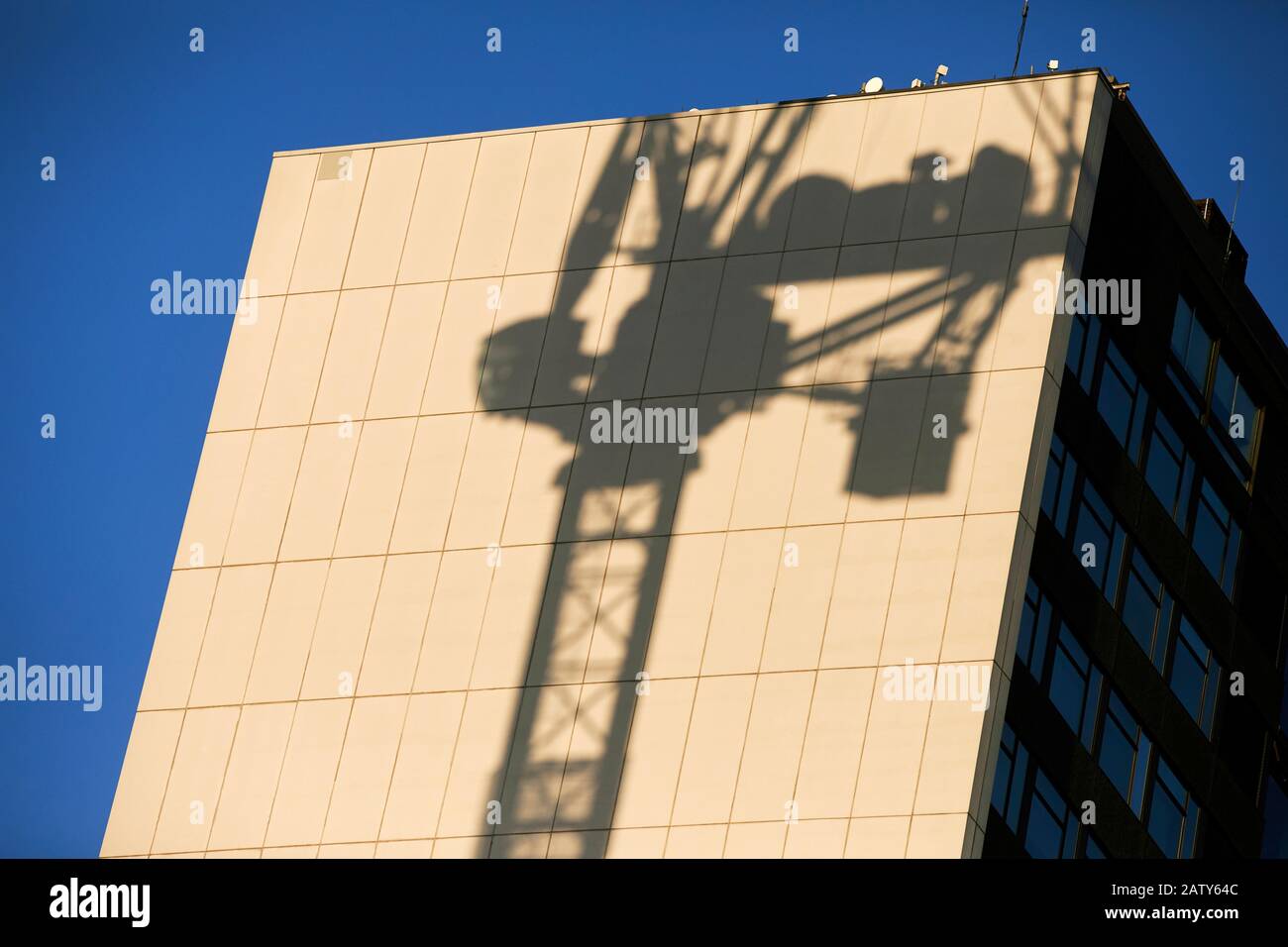 A tower crane shadow on an office building in Manchester Stock Photo ...