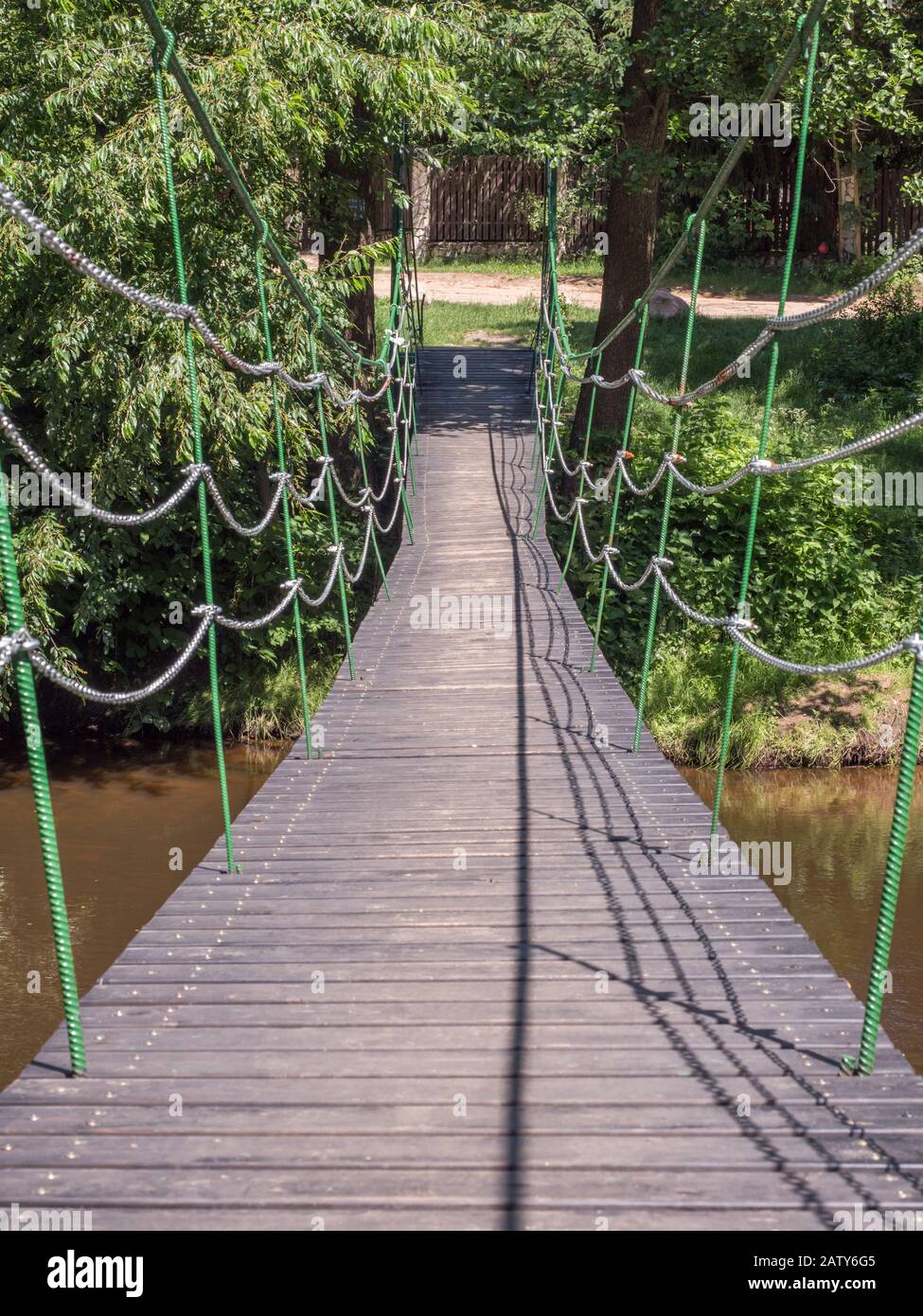 Swider River, Poland - October 05, 2016: Wooden bridge over a Swider ...