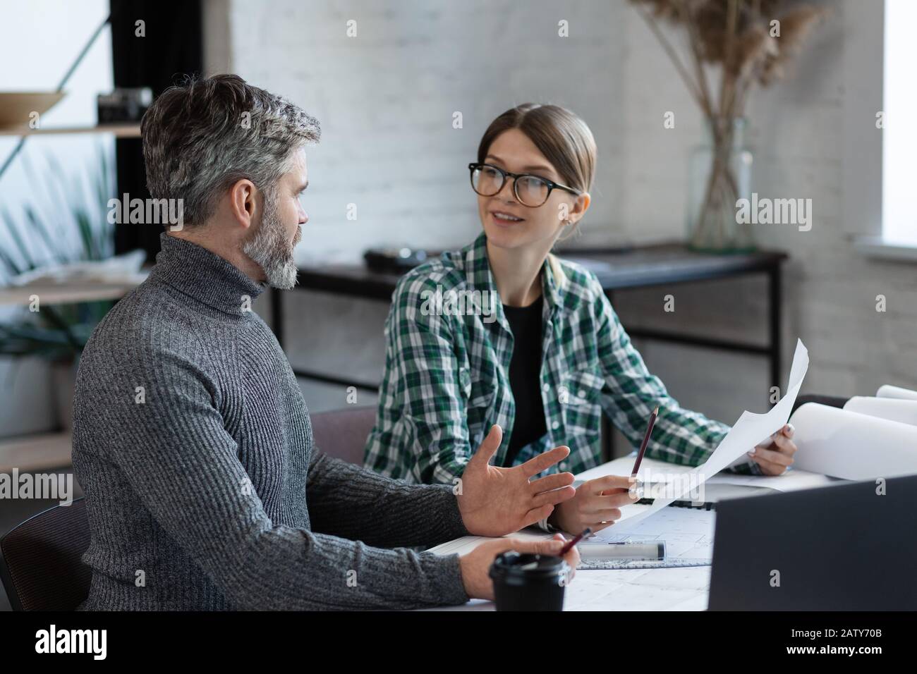 Interior designers team working in office with blueprints and architect ...